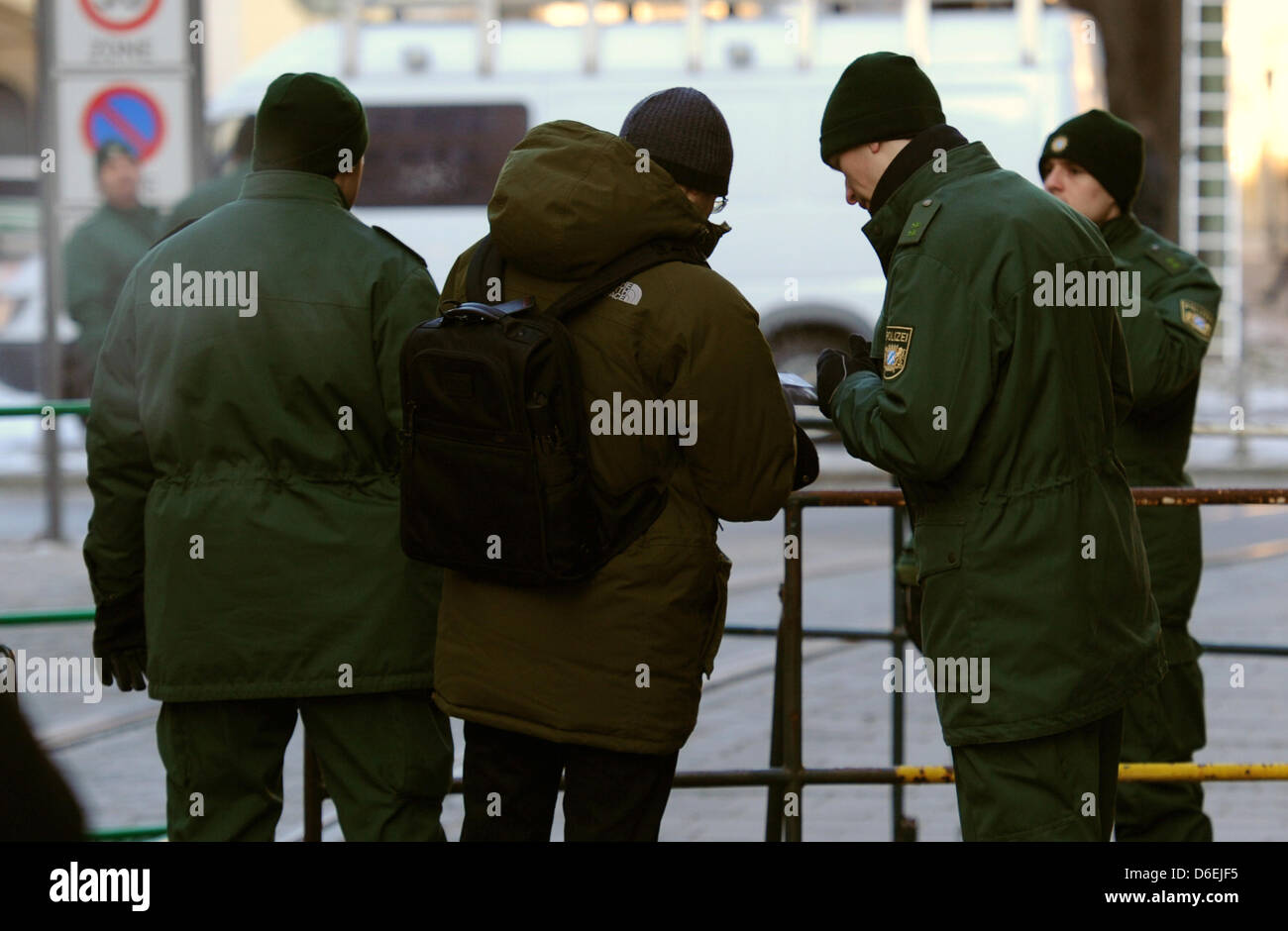 Police check a man in the access road to the Hotel Bayerischer Hof on ...