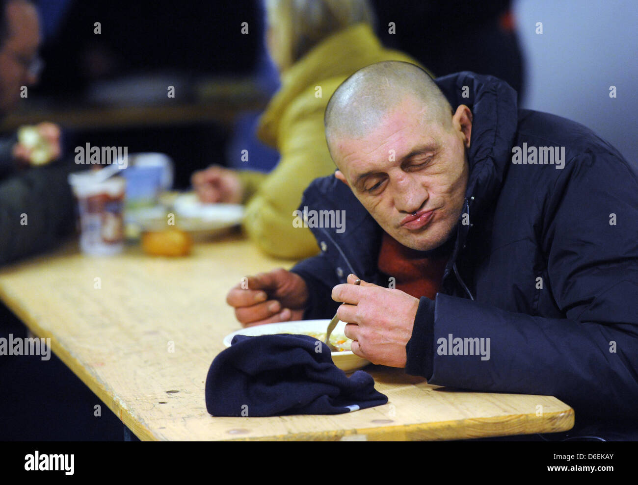 A homeless man receives something to eat at the city mission in Berlin ...