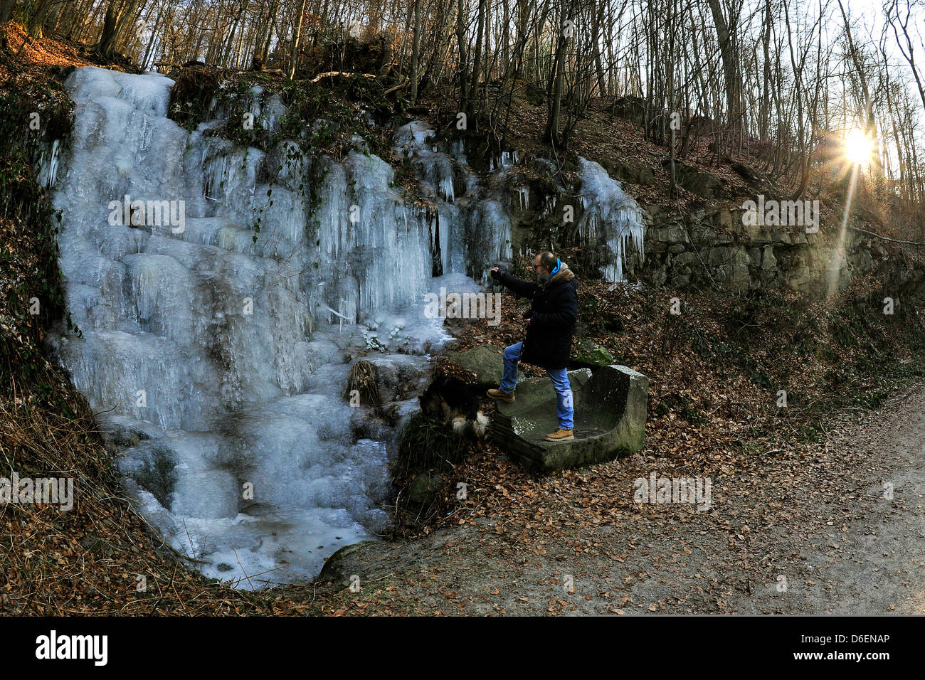 A man takes a picture of a frozen waterfall in Solingen, Germany, 06 ...
