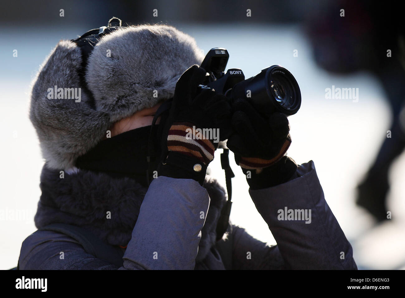 A tourist wears warm clothes as she take a photo of the Dome in Cologne ...