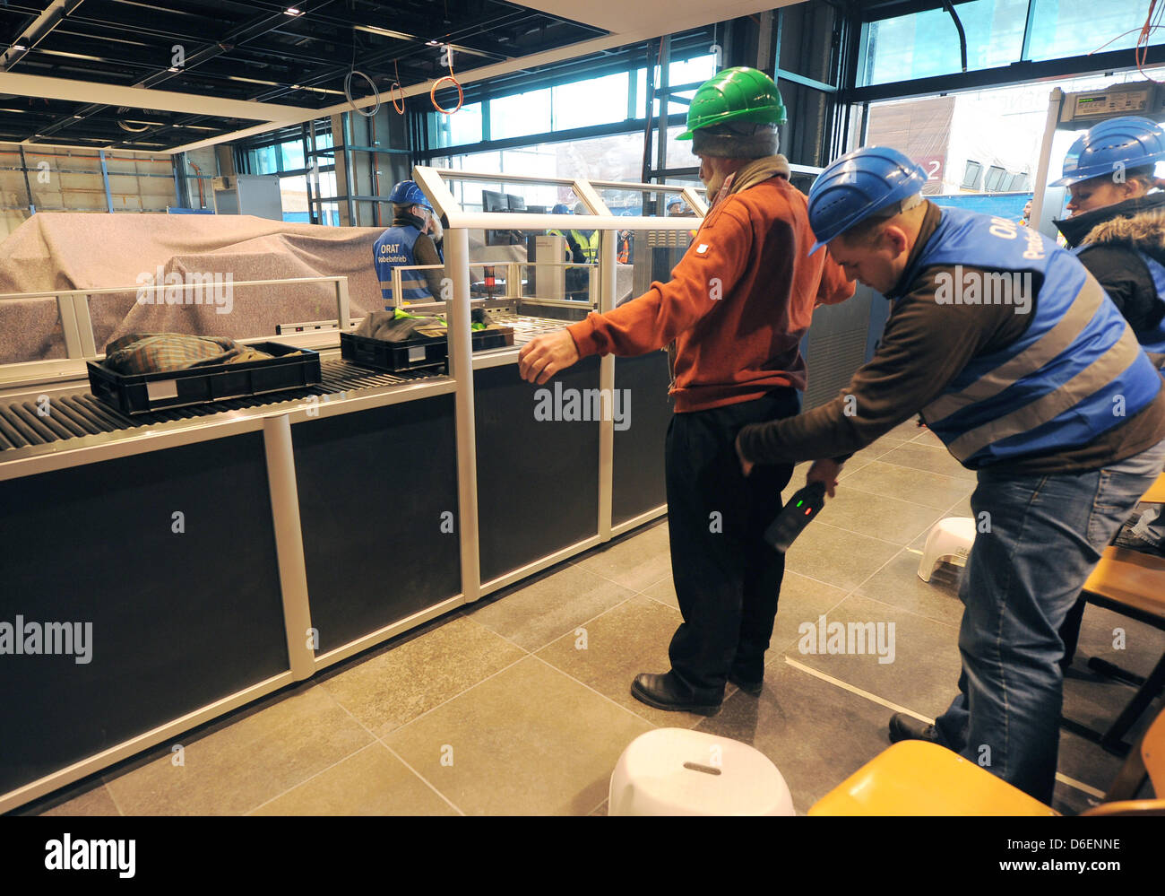Police officers work at the Security Check during the trial operation ...