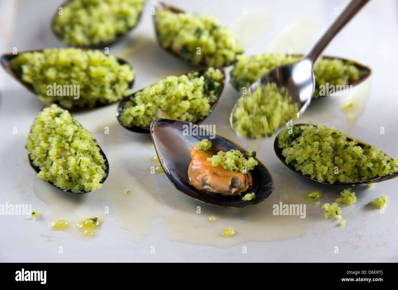 Preparing mussels in half-shell with Provencale crumb/ step shot Stock ...