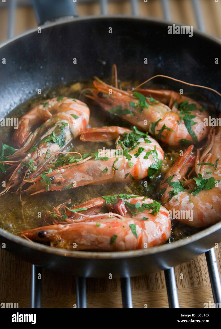 King prawns cooking with olive oil/ garlic / lemon / parsley/ step shot ...
