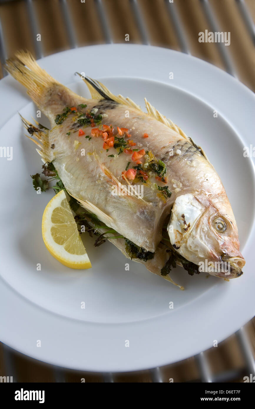 Cooked St Peter's fish with herbs and chilli relish/ step shot Stock ...