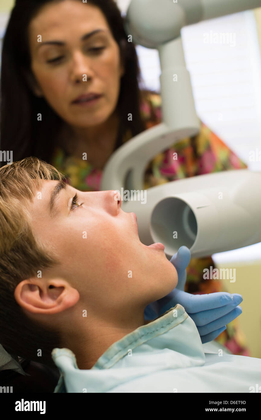 Nurse using equipment on dental patient Stock Photo - Alamy