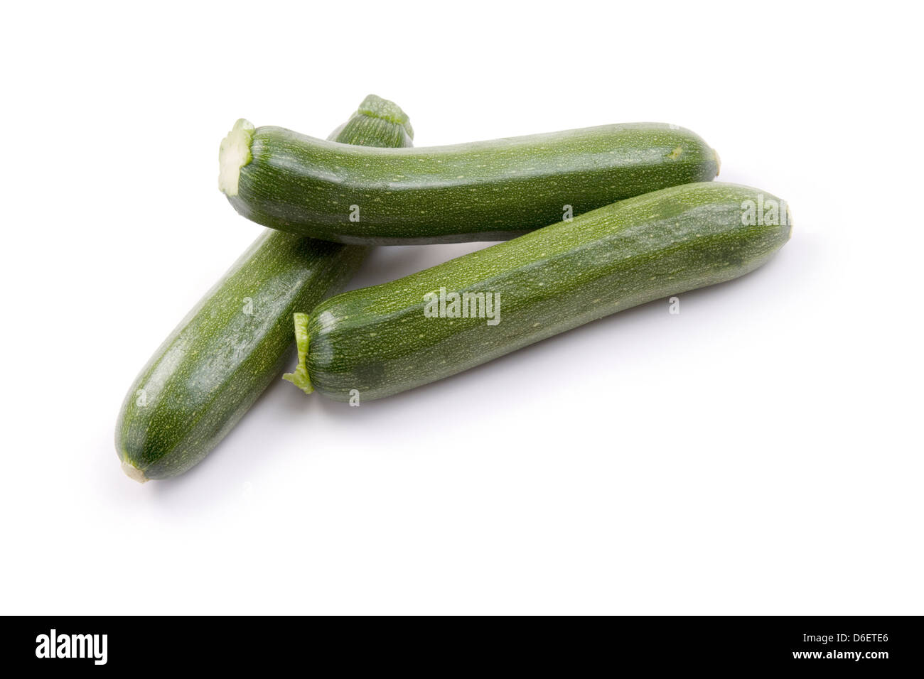 Whole courgettes on white background Stock Photo - Alamy