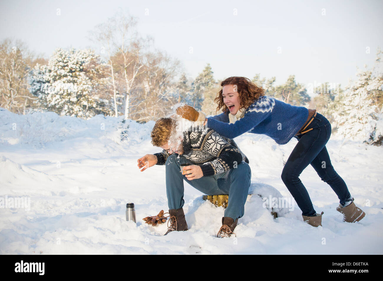 Young man playing in the snow hi-res stock photography and images - Alamy