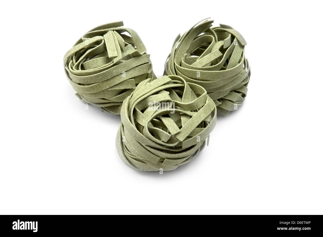 Dried Tagliatelle verde pasta on white background Stock Photo - Alamy