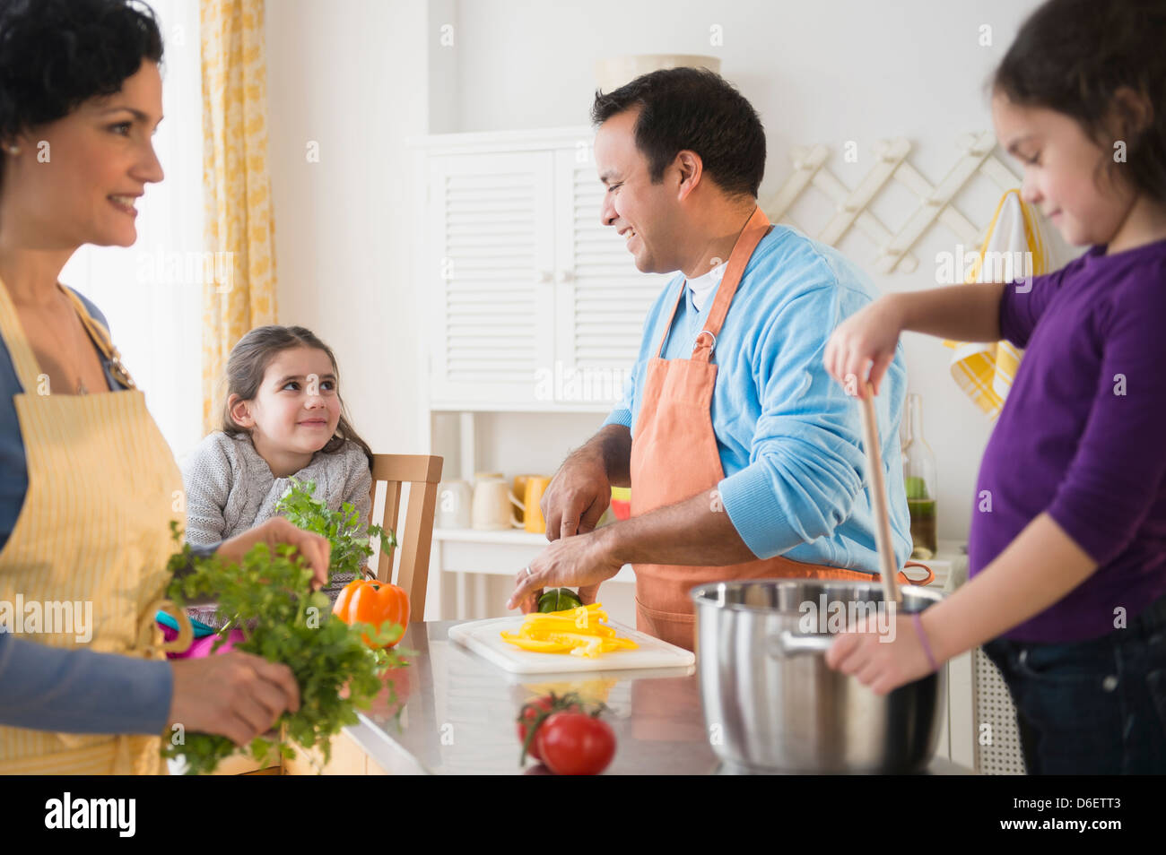 Family cooking together in kitchen Stock Photo - Alamy