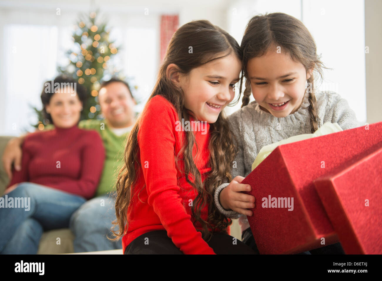 Happy family opening present hi-res stock photography and images - Alamy