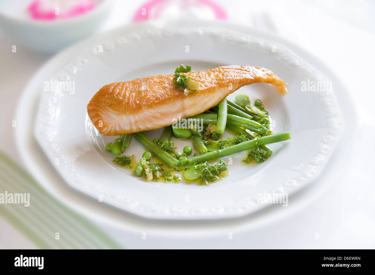 Pan fried Salmon fillet served on a bed of mixed green beans Stock ...