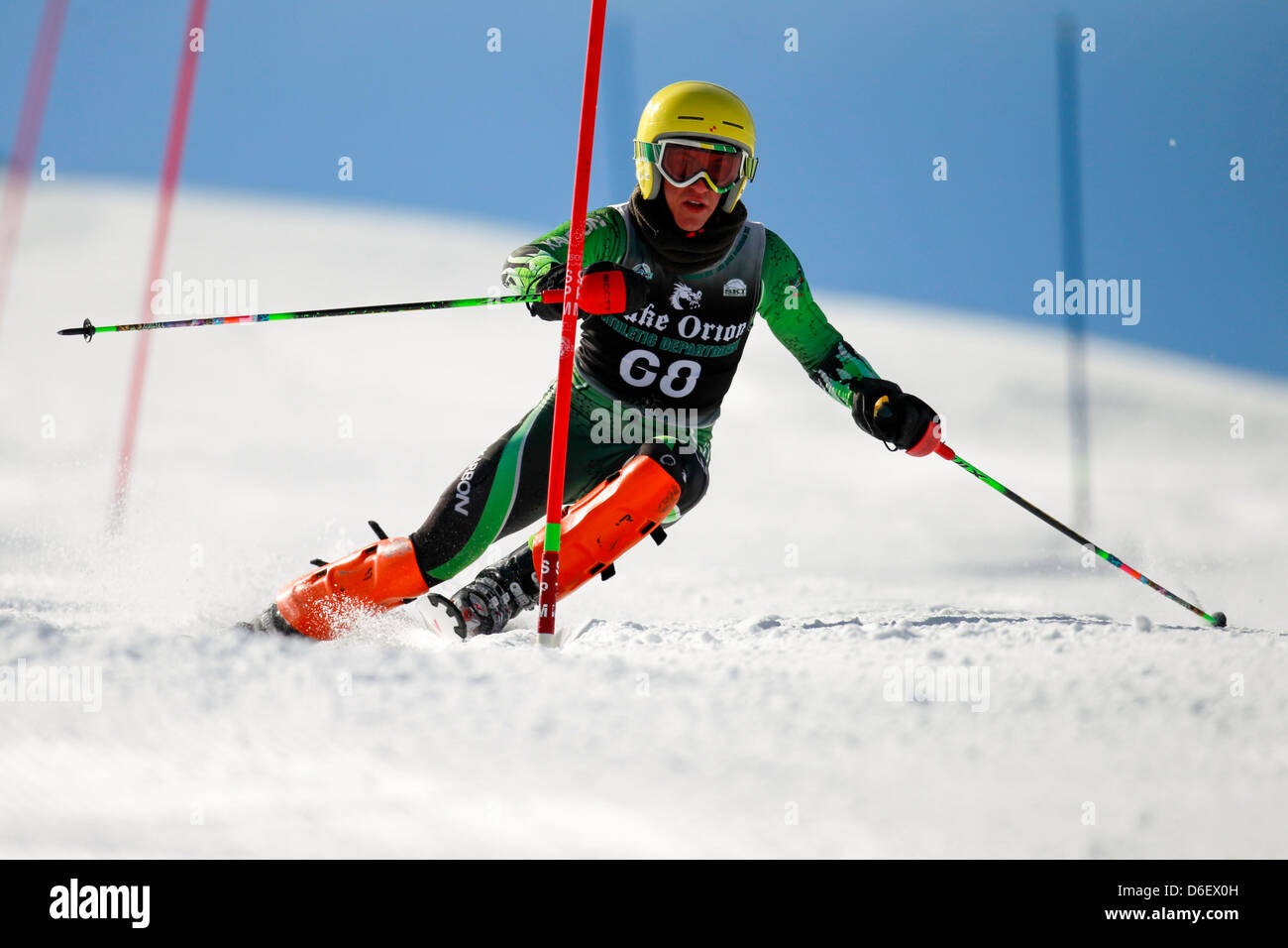 An alpine skier at a gate while racing on the slalom course Stock Photo ...