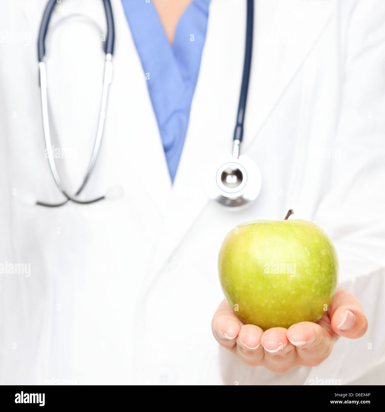 Health care. Doctor giving apple. An apple a day keeps the doctor away ...