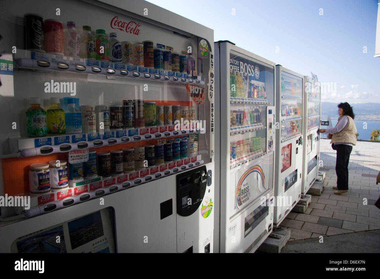 woman using vending machines in the city of Hakodate, Hokkaido in Japan ...
