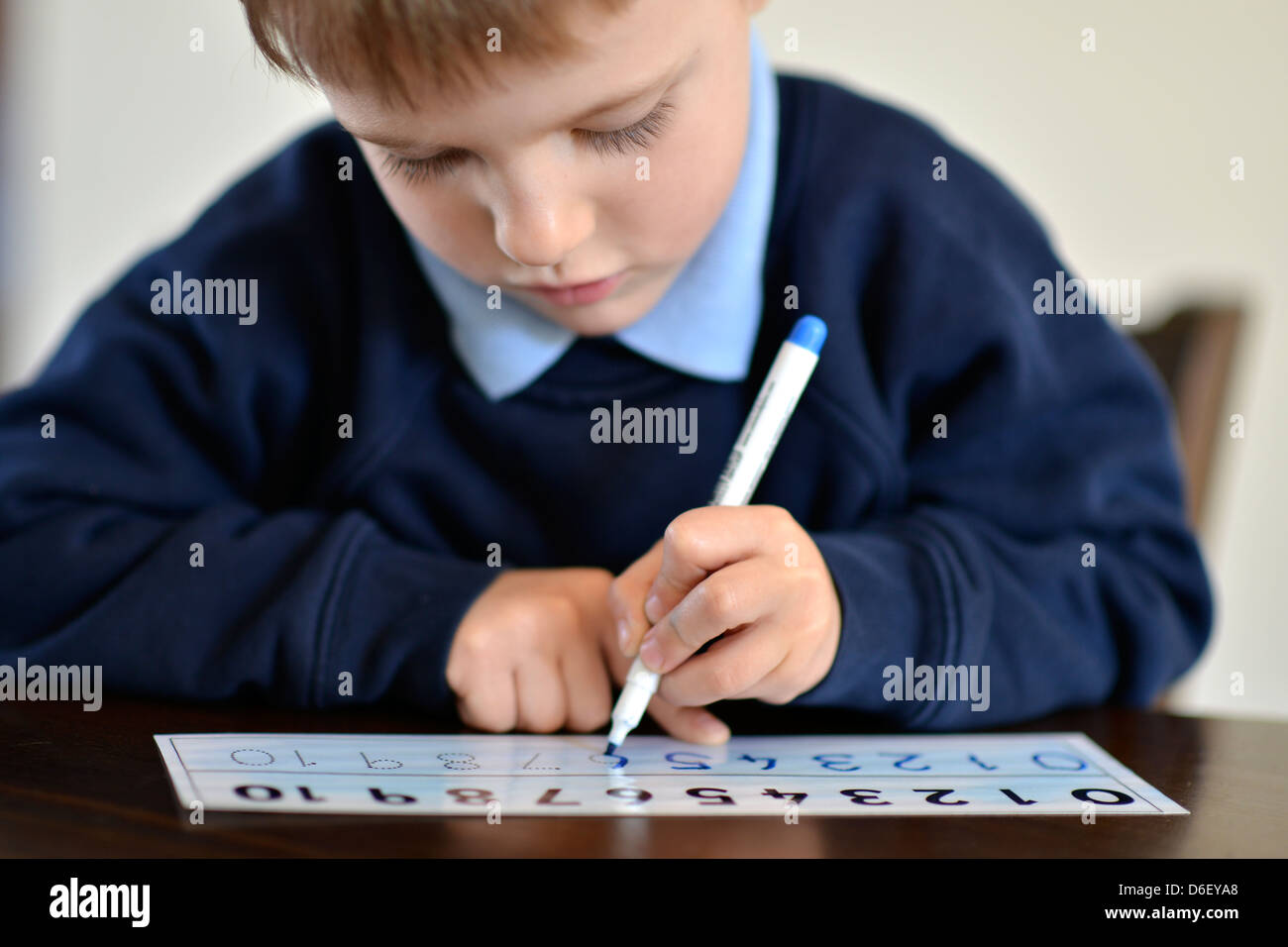A five year old schoolboy learning how to write numbers Stock Photo - Alamy
