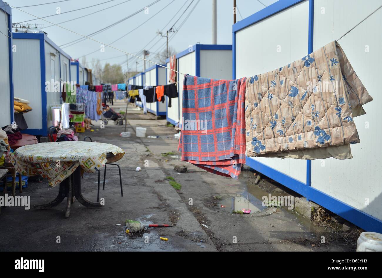 A view down a narrow alleyway between makeshift housing containers in ...