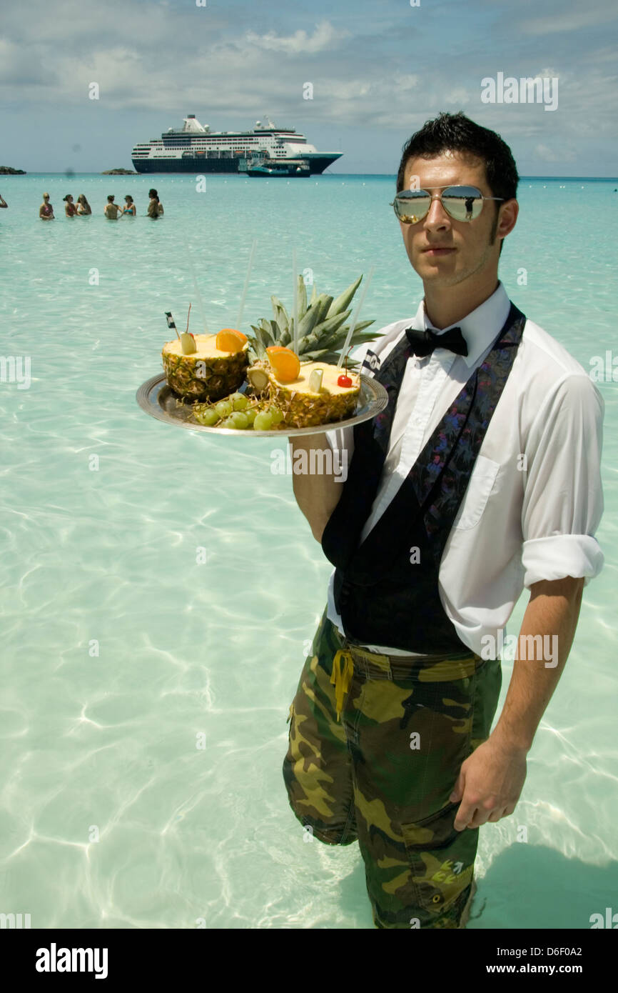 waiter standing in the water with fresh fruit and drinks at Half Moon ...
