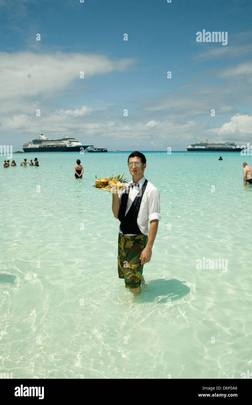 waiter standing in the water with fresh fruit and drinks at Half Moon ...