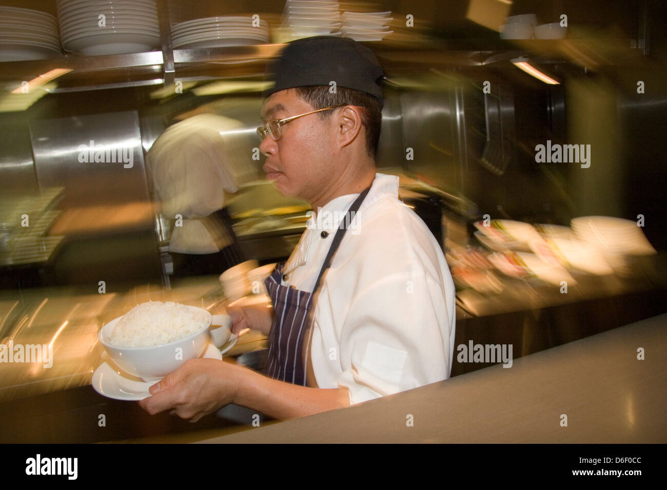 Line cook caries a bowl of rice at The Malaya Restaurant in Sydney ...