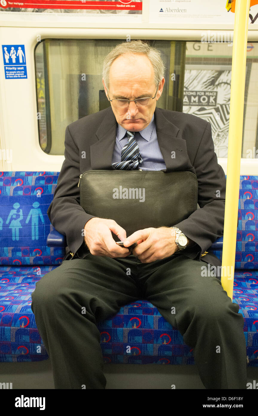 Businessman makes use of free time on London Underground with his ...