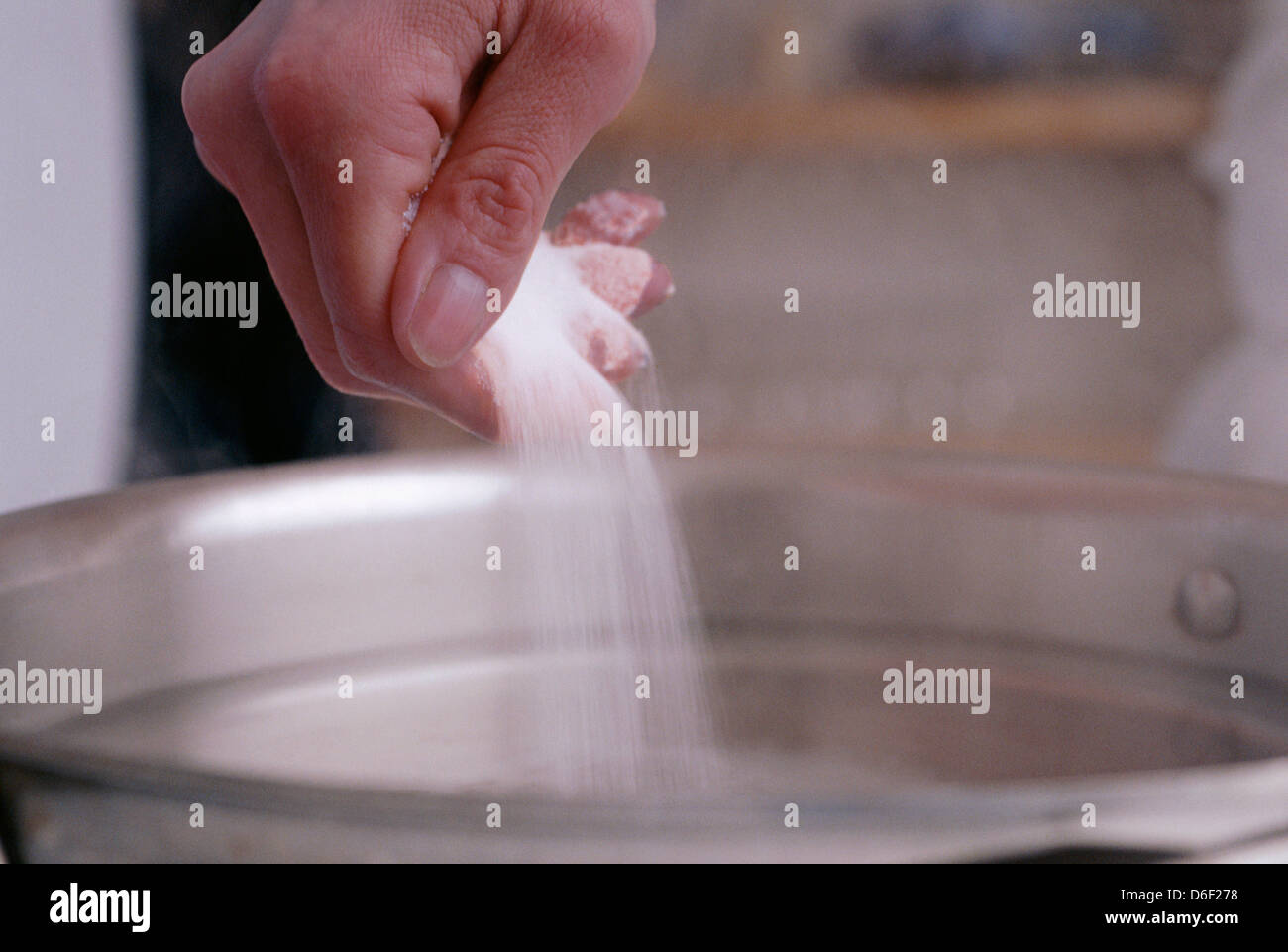 Adding Salt to a Pan Stock Photo - Alamy