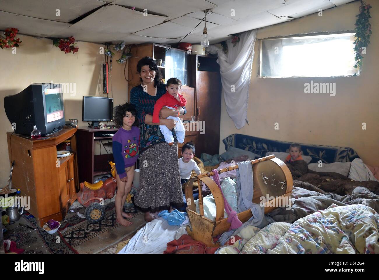 Mother Serjana and her children stand in a room of their makeshift ...