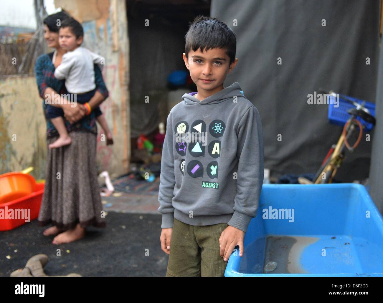 Mother Serjana (L) and her children stand in front of their makeshift ...