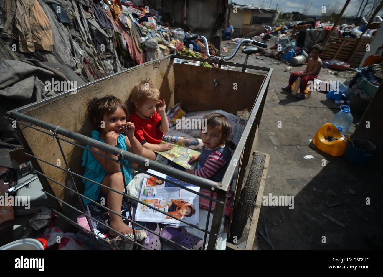 Children play between piles of rubbish in the Belvil settlement, which ...