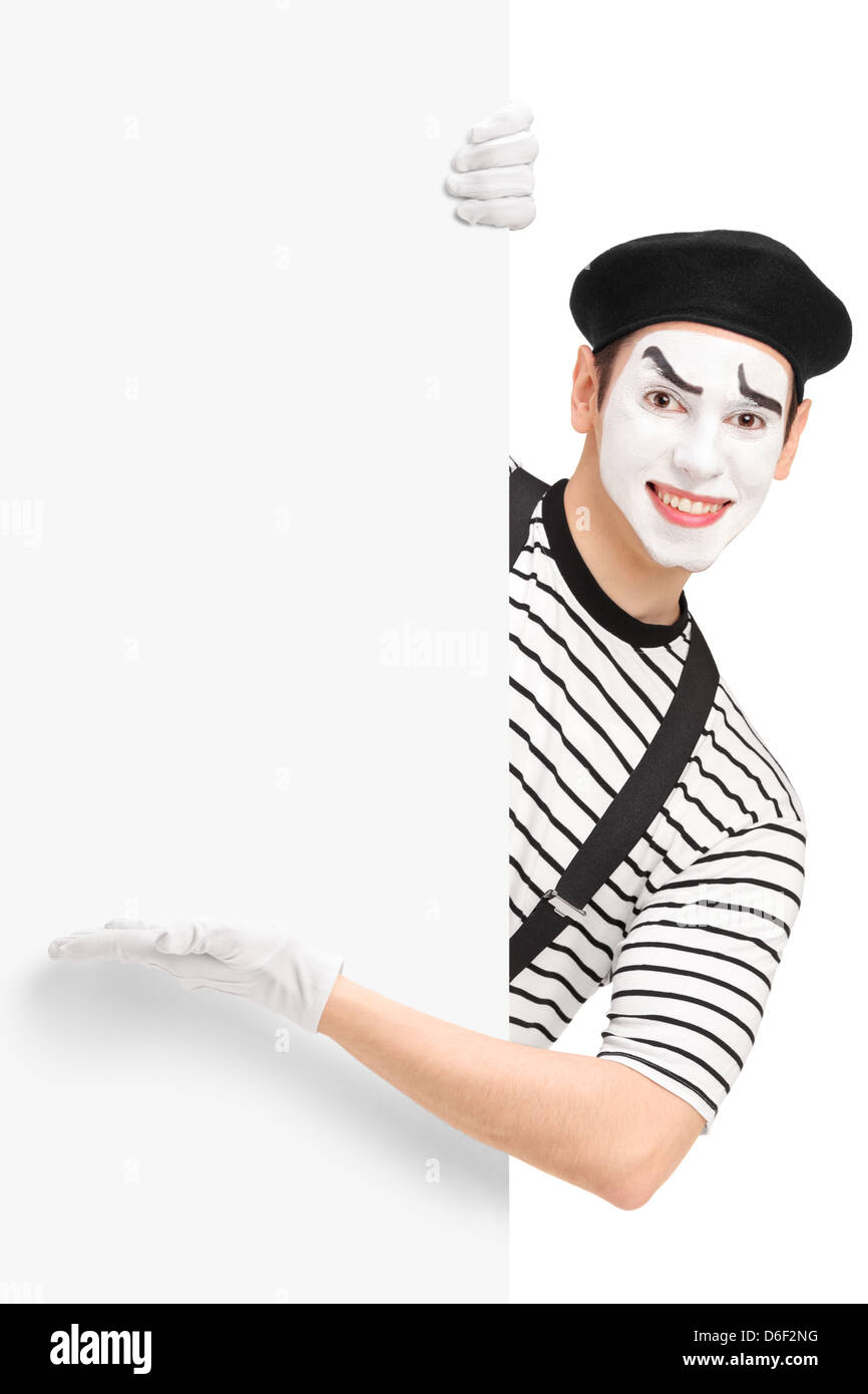Smiling male mime artist showing on a panel, isolated on white ...