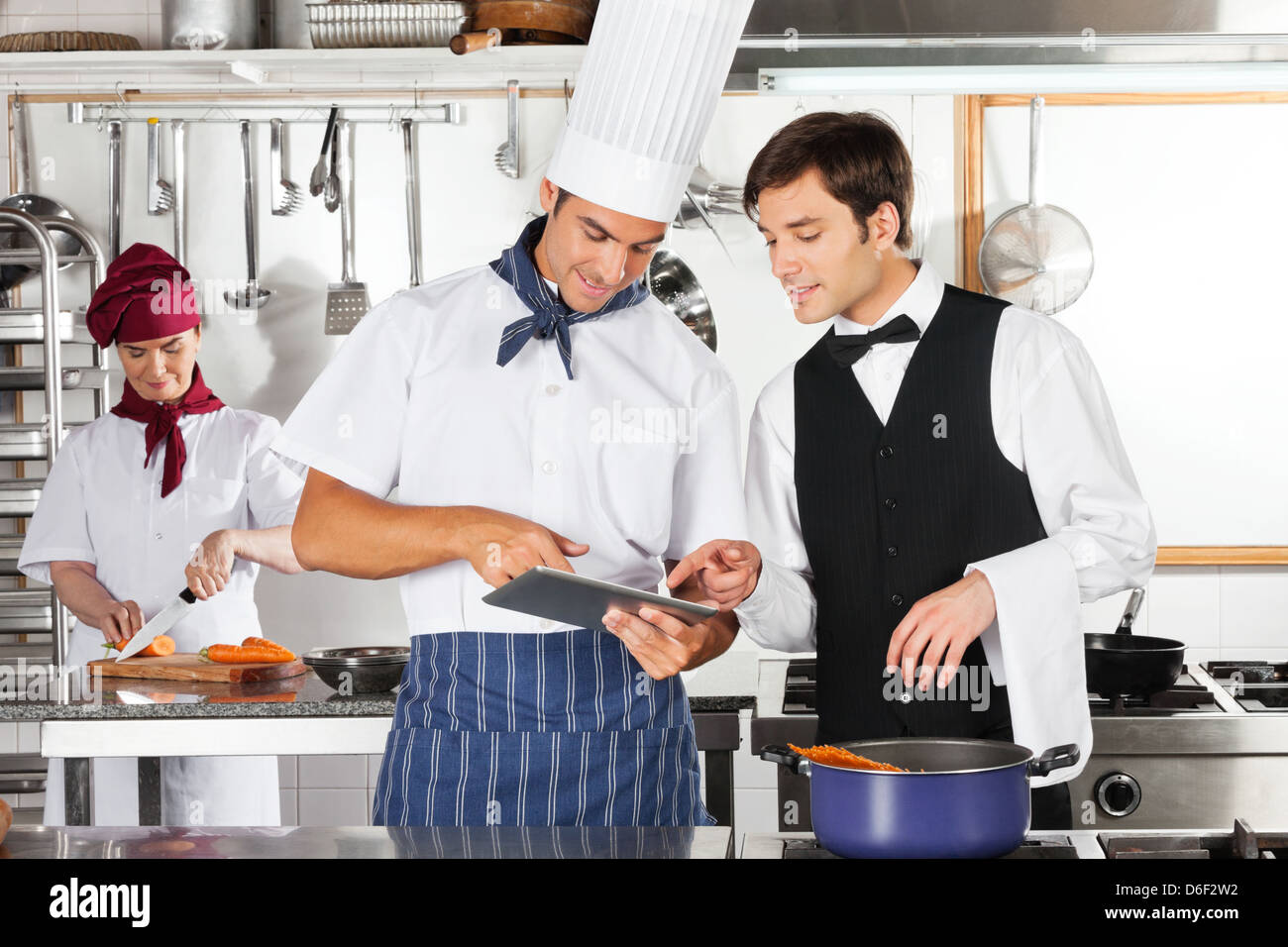 Waiter And Chef Using Digital Tablet In Kitchen Stock Photo - Alamy