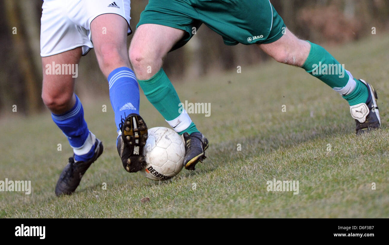 Two soccer players vie for the ball during the district league soccer ...