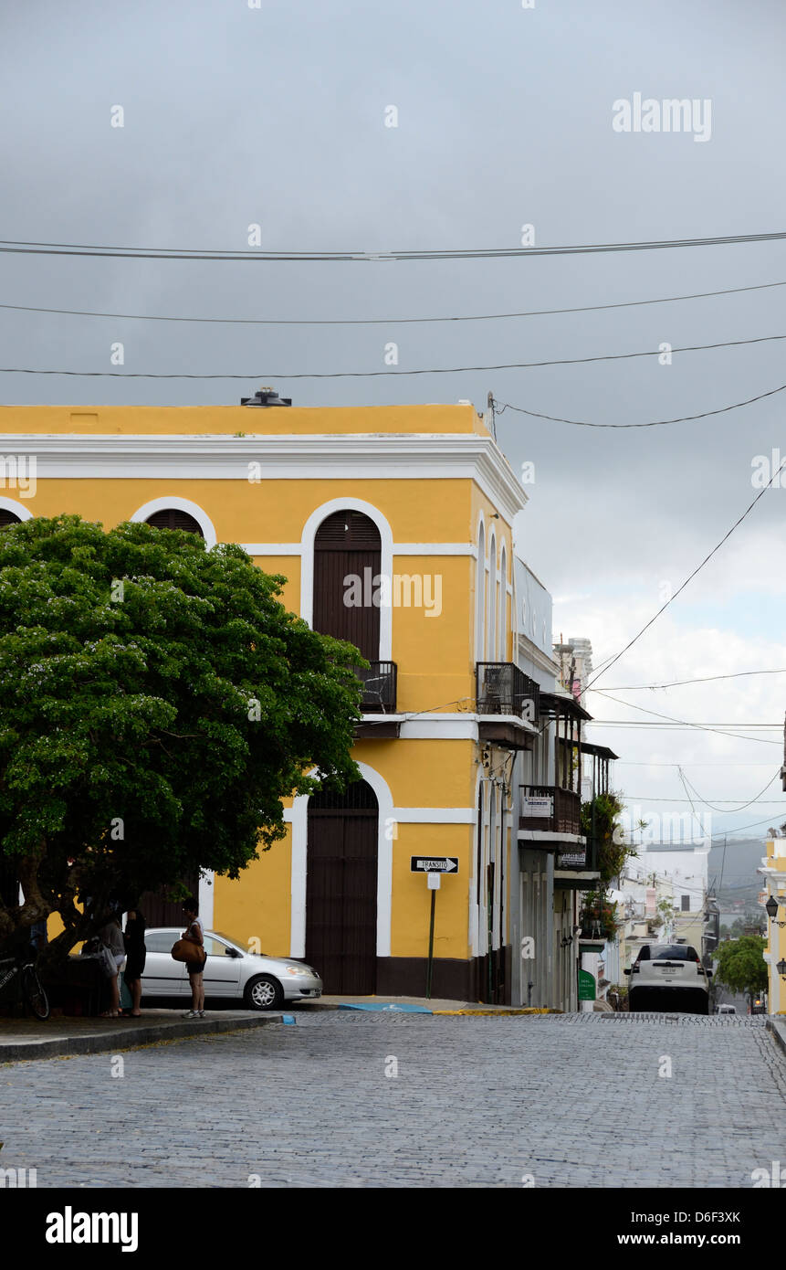Yellow building and cobblestone street in Old San Juan, Puerto Rico ...