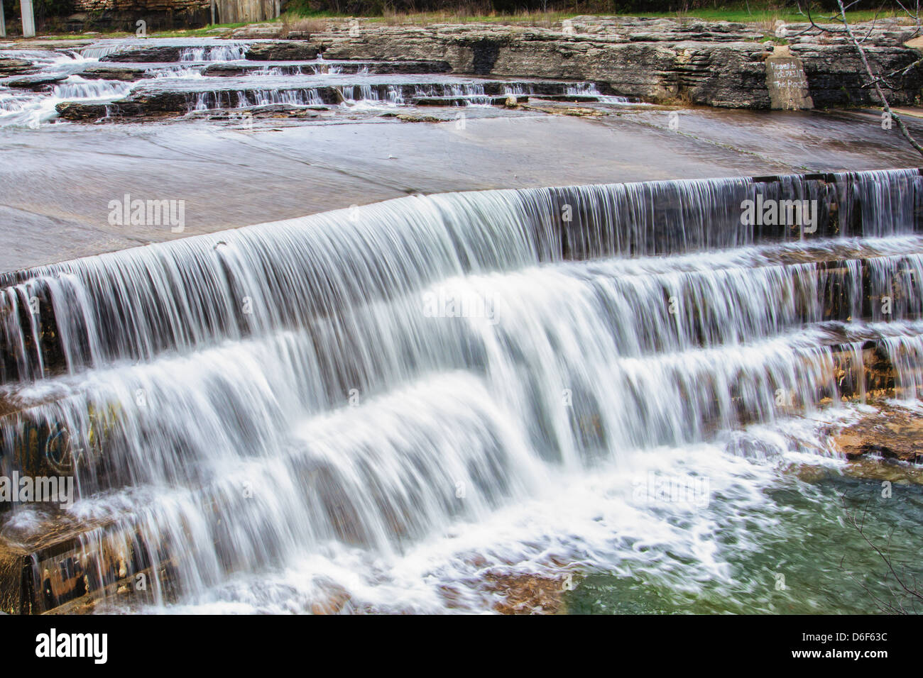 Moving water over a falls and spillway stream Stock Photo - Alamy
