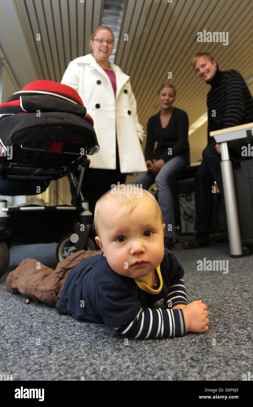 Handewitt, Germany, a toddler crawls over the bottom of a ...