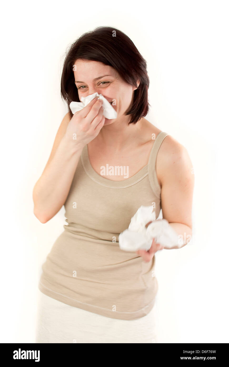 sneezing and laughing allergies ill woman with tissues Stock Photo - Alamy