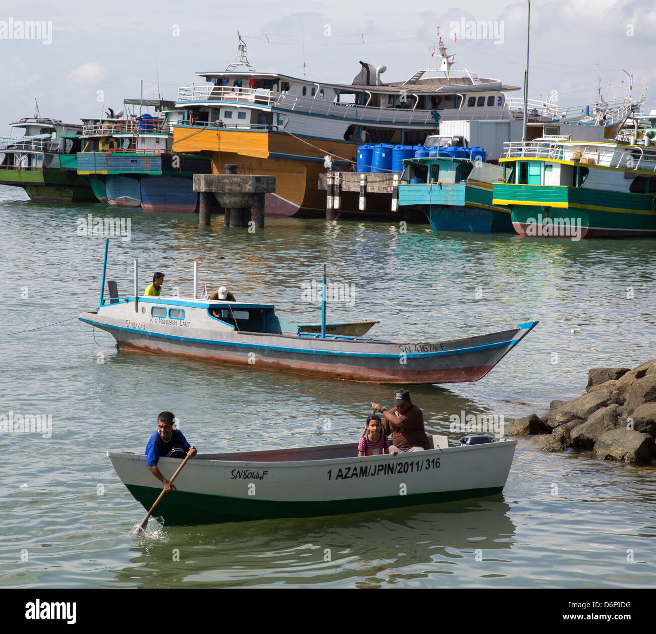 Boats big and small in the busy harbour of Sandakan in Sabah Malaysian ...