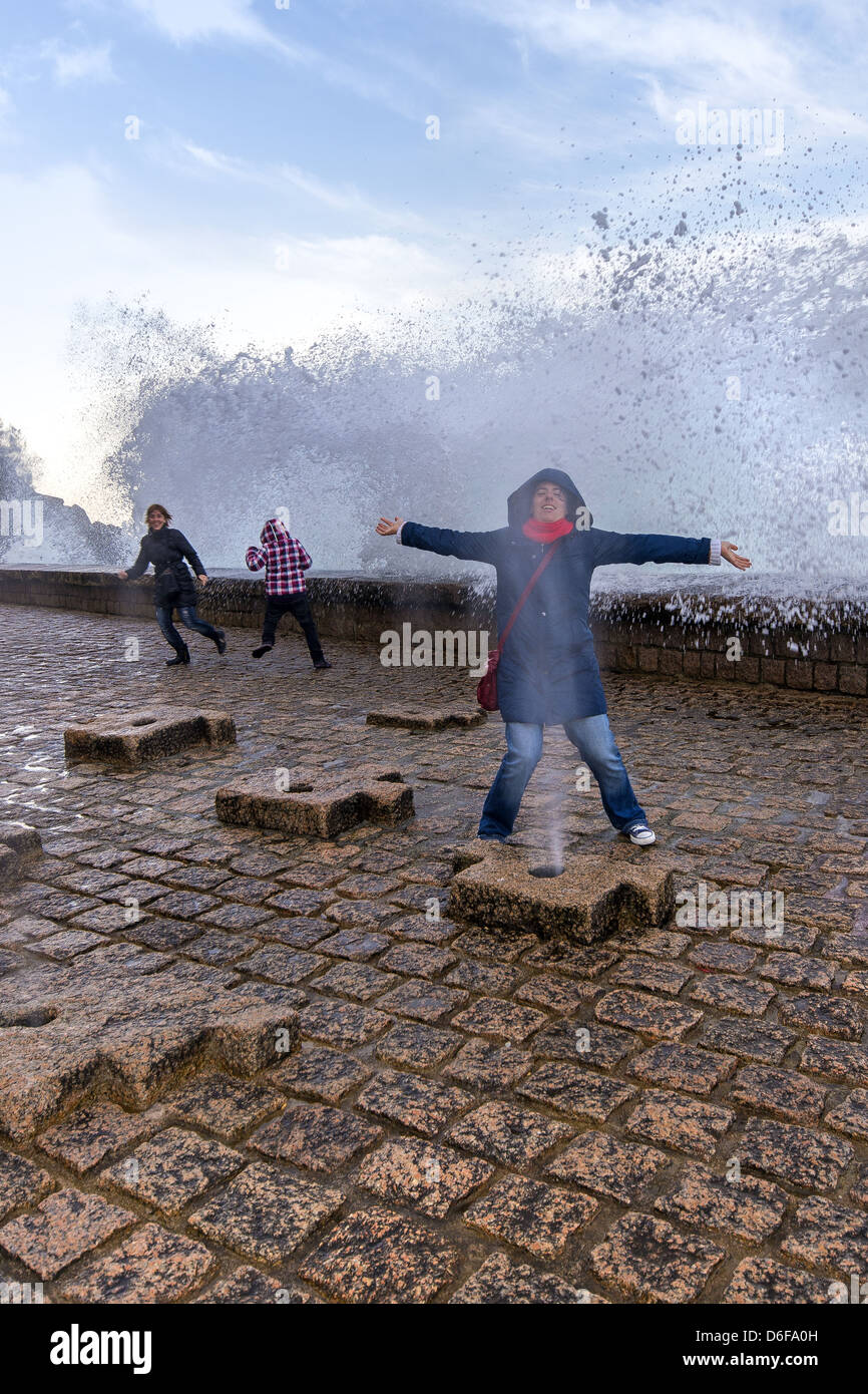 People getting soaked by freak waves coming over and up through harbour ...