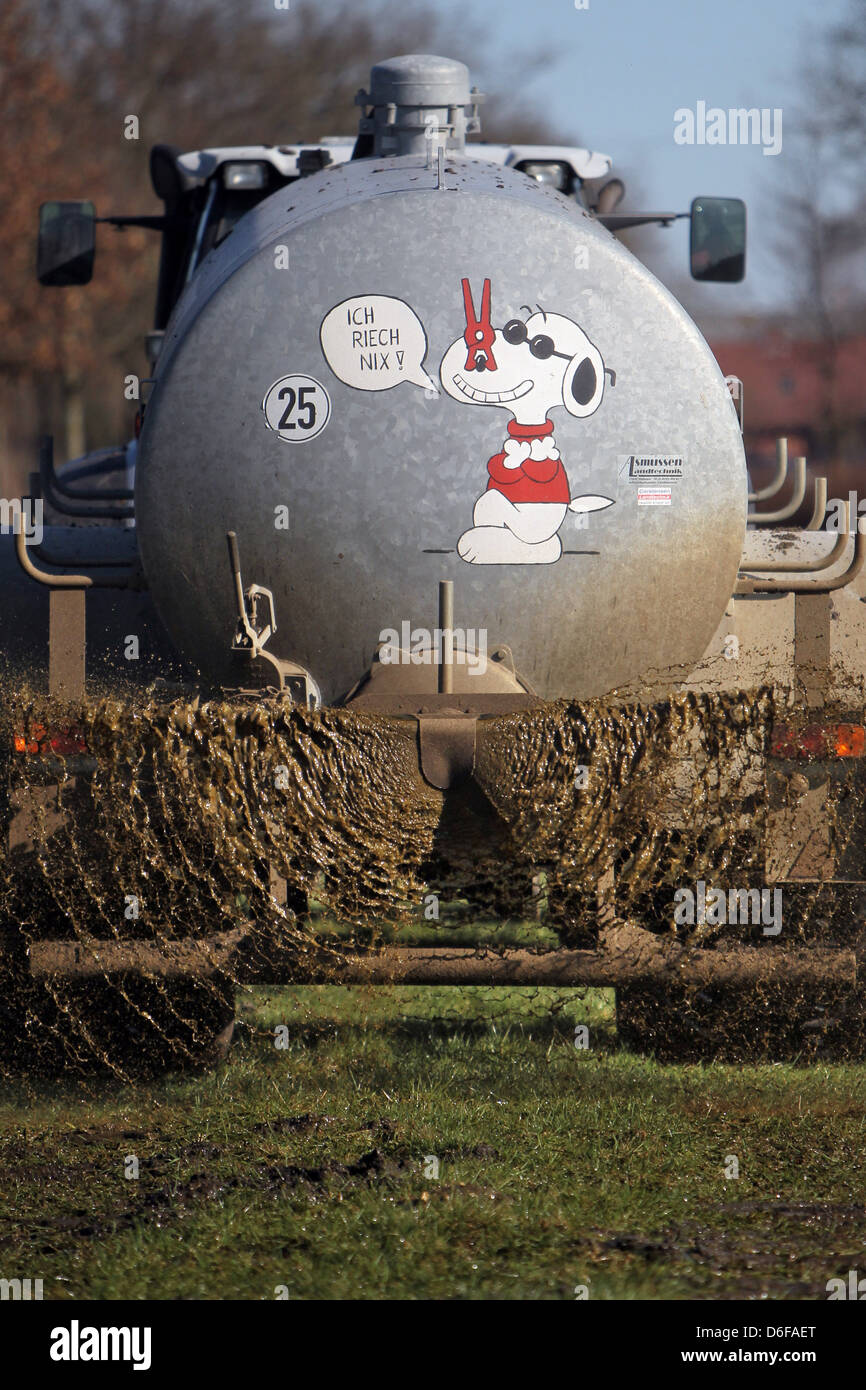 Haselund, Germany, Fluessigdungstreuer with Snoopy drawing on the field ...