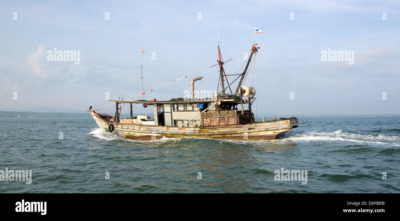 A Sabah fishing boat sailing rapidly back to Sandakan harbour to unload ...