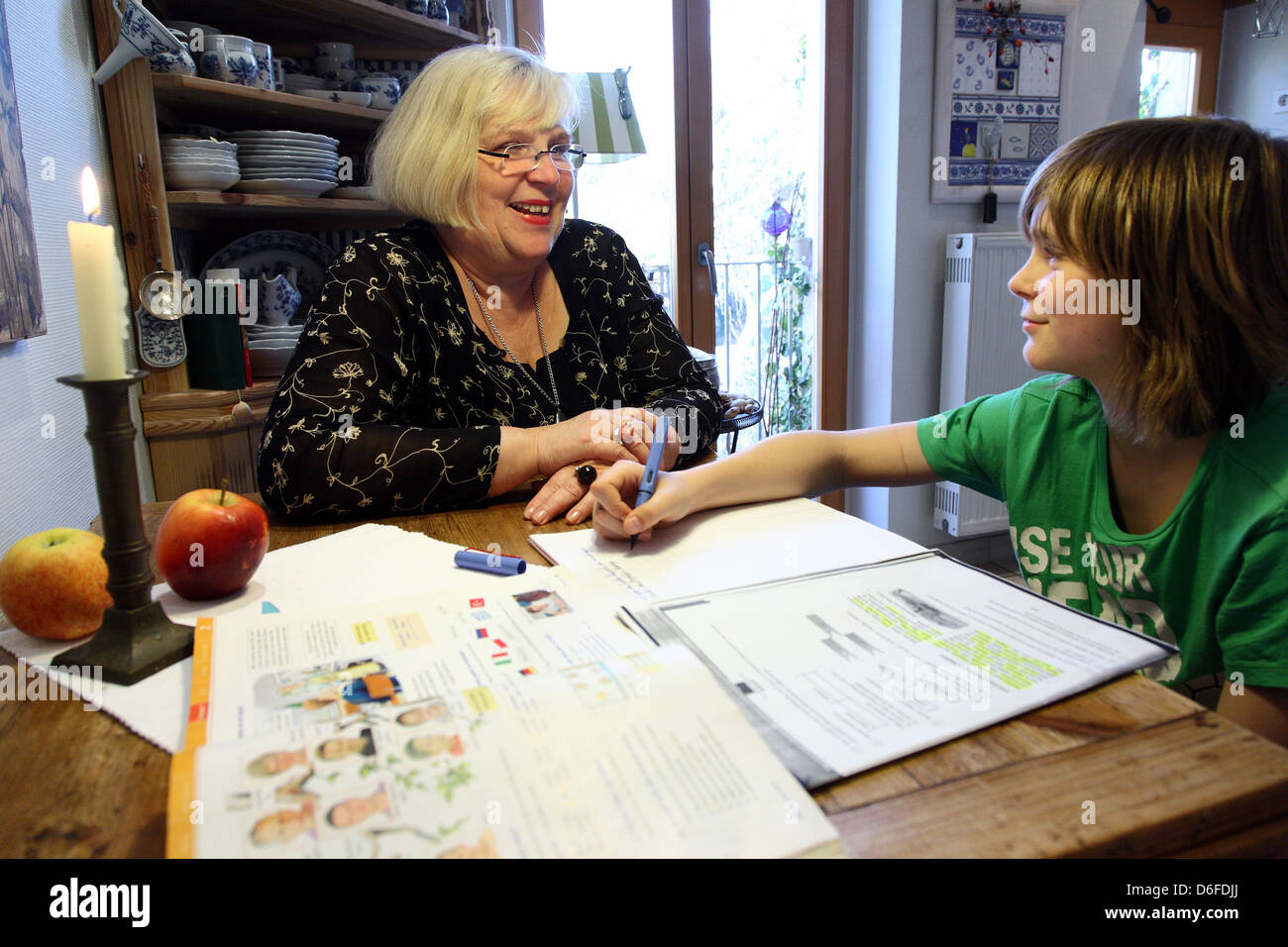 Berlin, Germany, granny helps her grandson with homework for school Stock Photo - Alamy