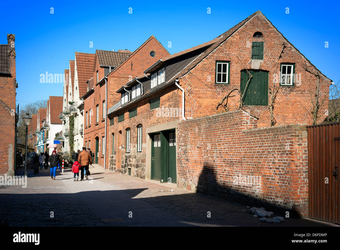 Street with shops, people and homes in Husum in good weather Stock ...