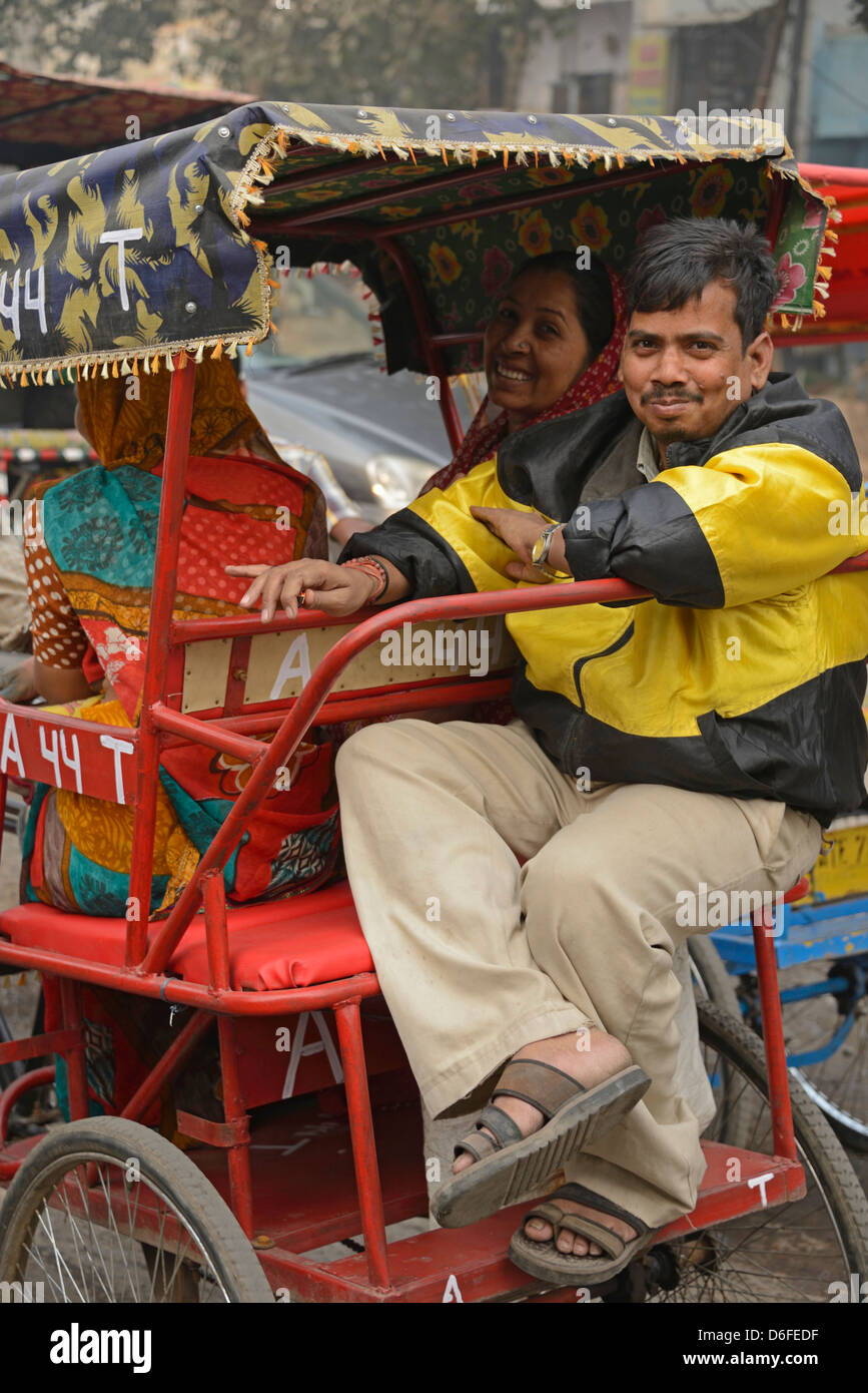 A couple sitting on the back of a rickshaw in Old Delhi in India Stock ...