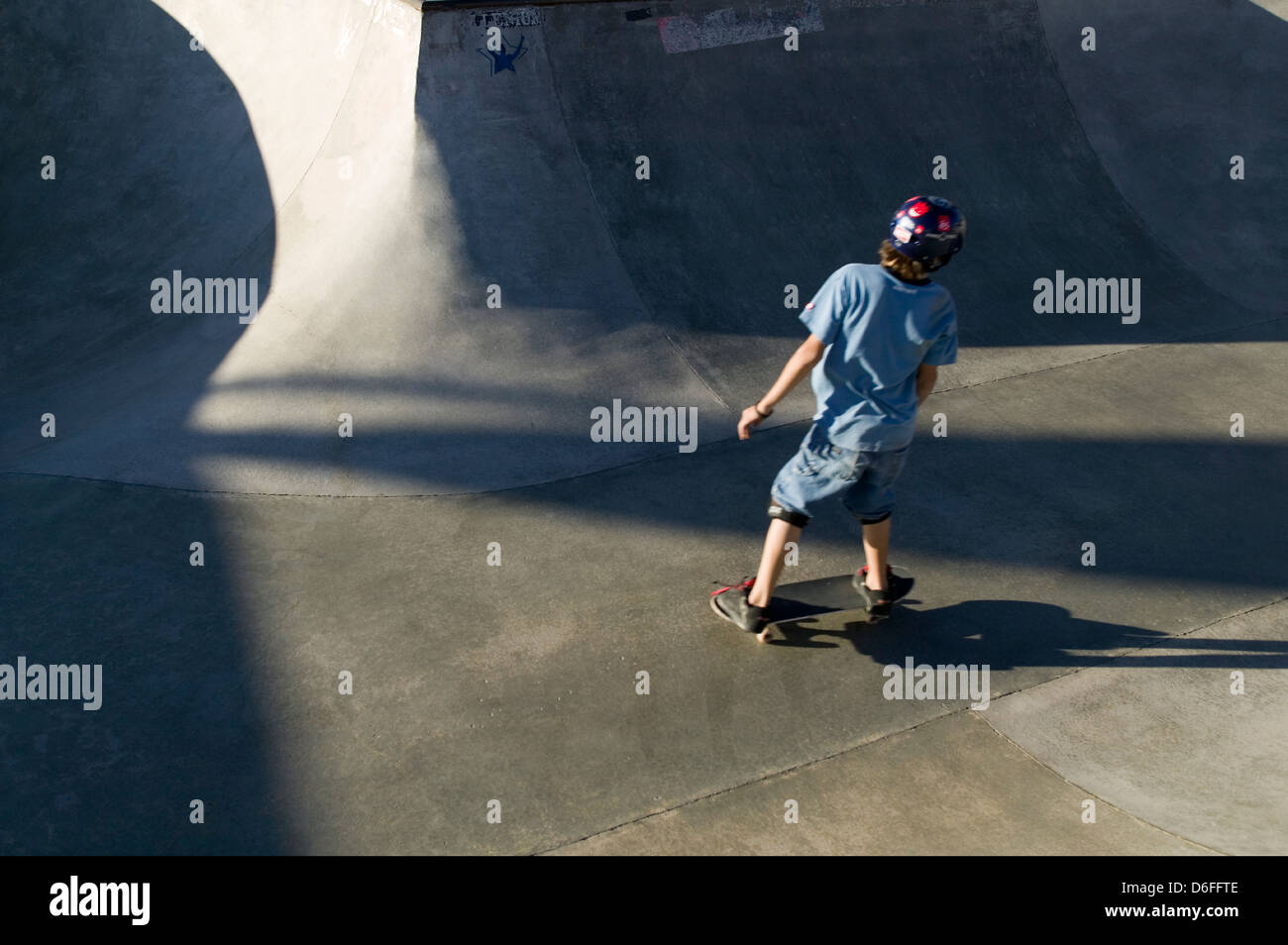 Teenage boy skateboarding in a small town skate park Stock Photo - Alamy