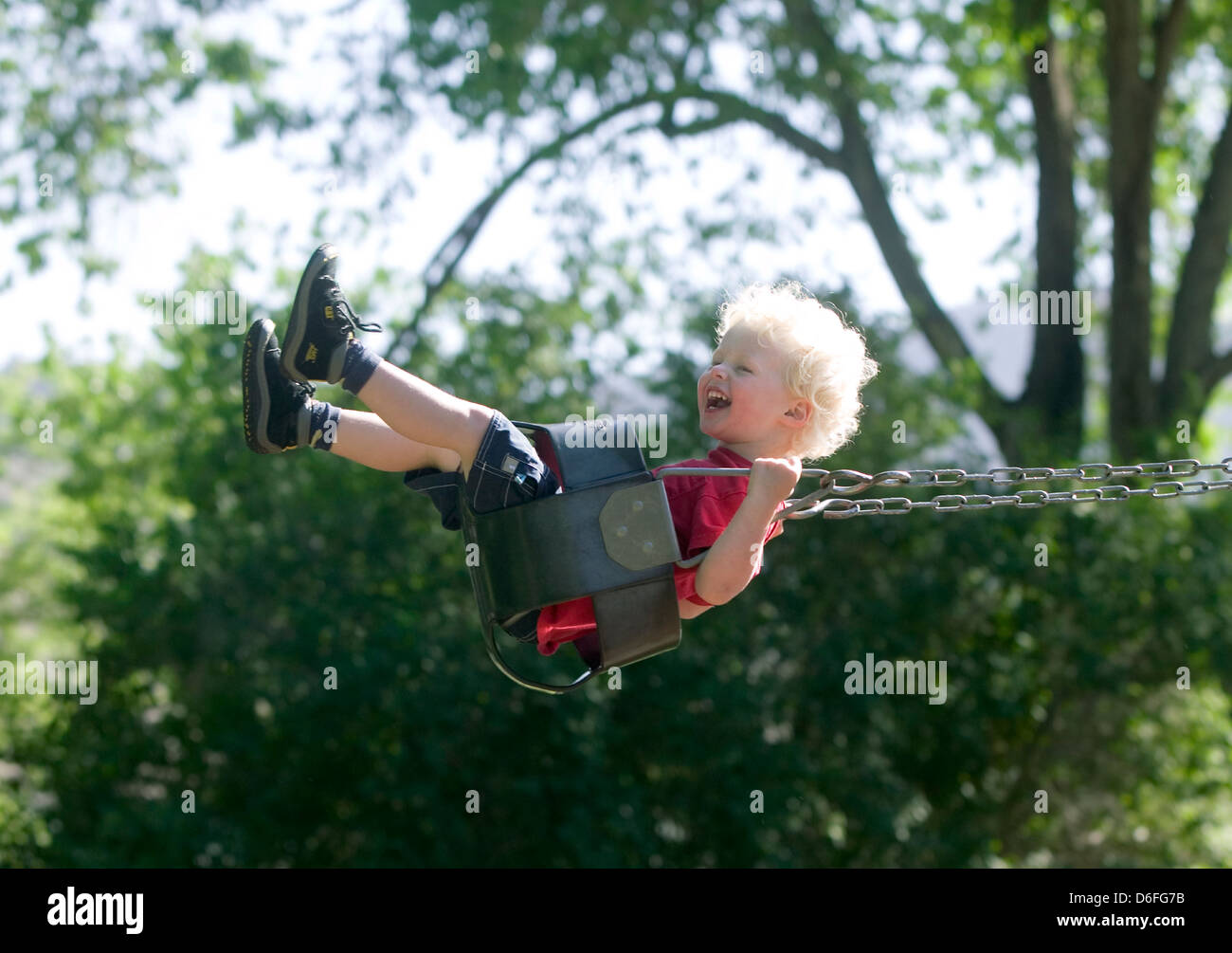 Beautiful boy swinging on swing hi-res stock photography and images - Alamy