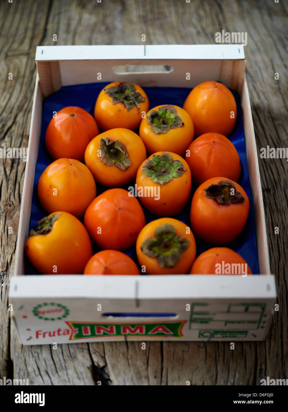 Box of Persimmons Stock Photo - Alamy