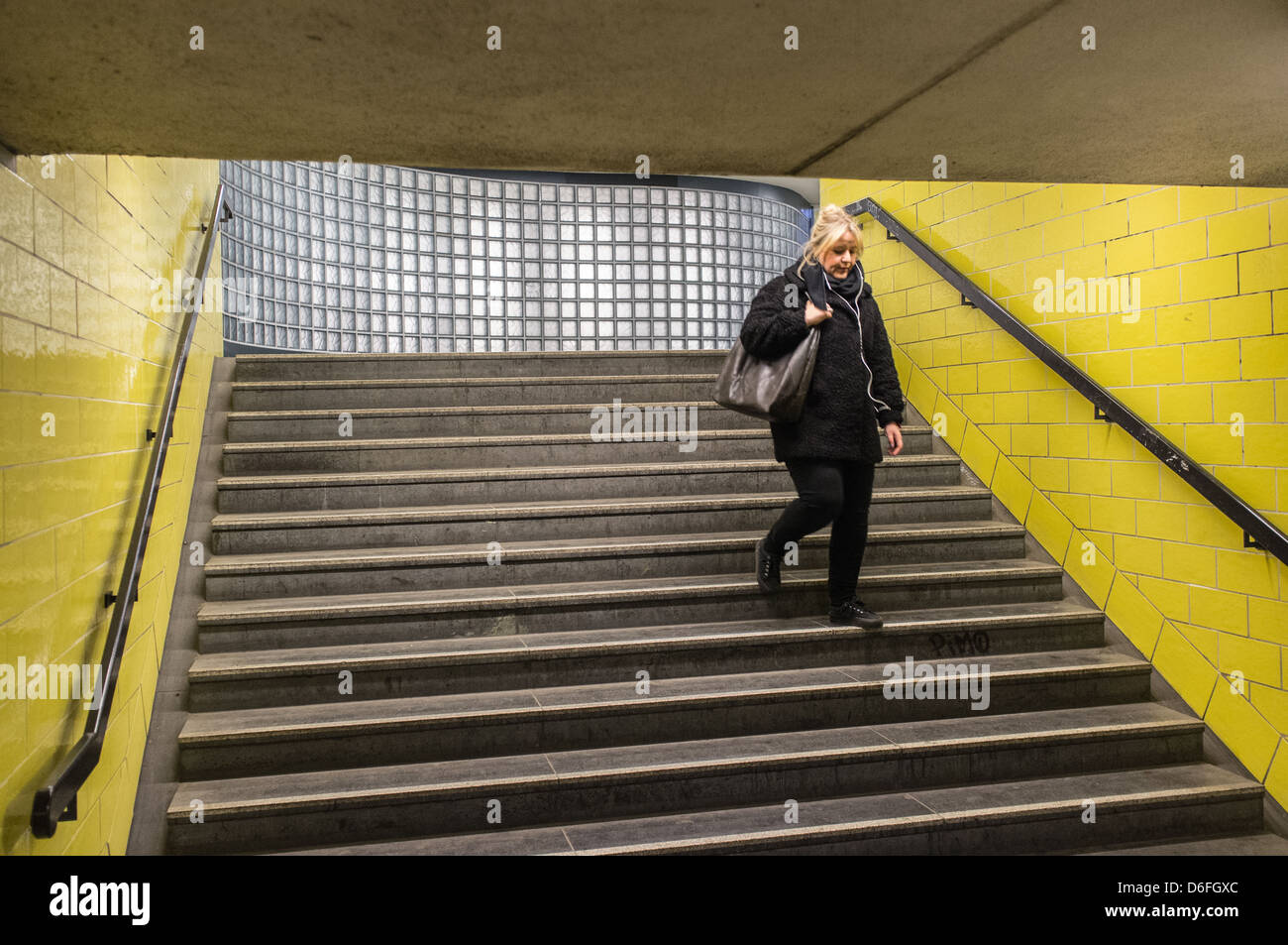 Woman walking down steps at a metro entrance in Berlin, Germany Stock ...