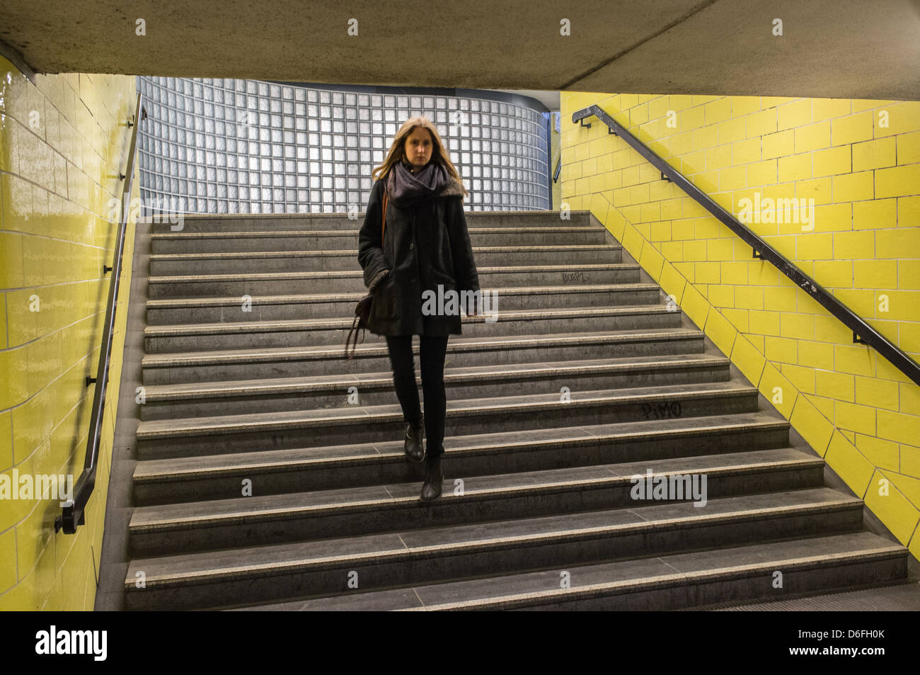 Woman walking down steps at a metro entrance in Berlin, Germany Stock ...