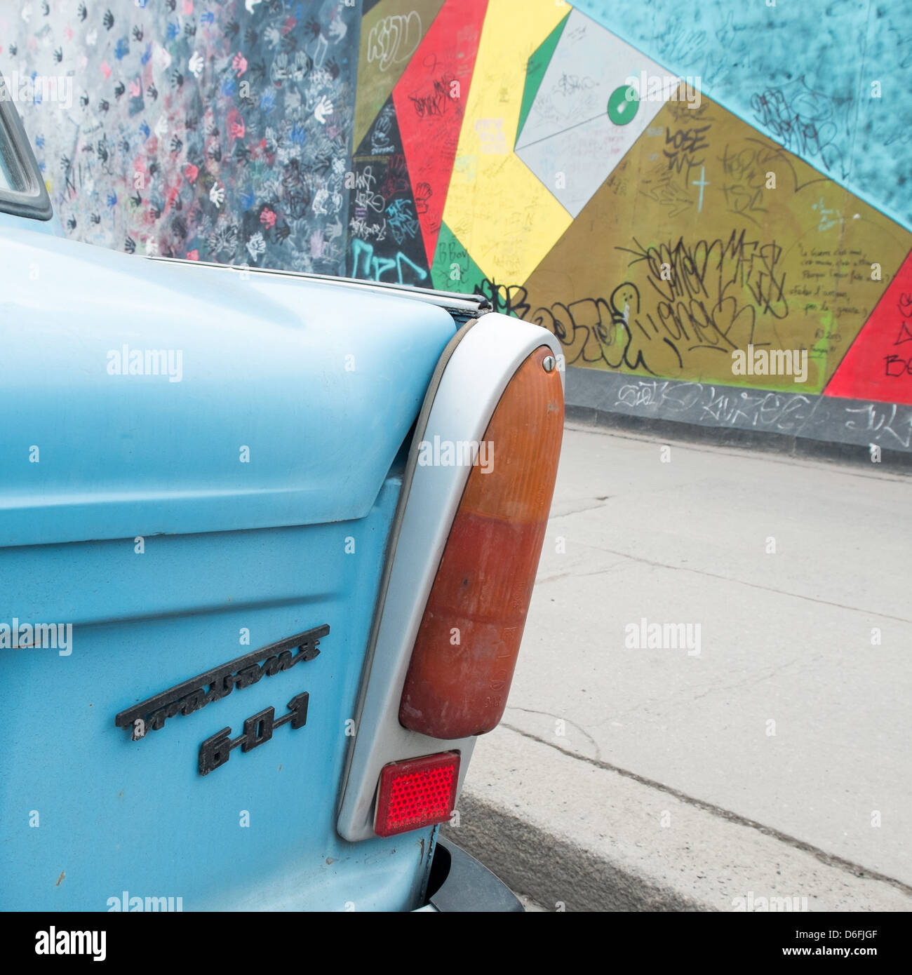 Trabant motor vehicle parked adjacent the Berlin Wall at the Eastside ...