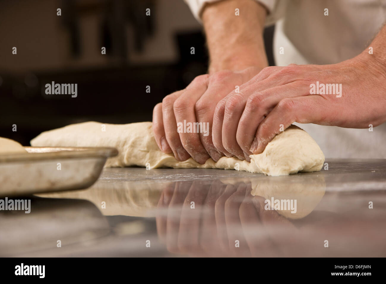 Professional cook preparing fresh bread in a commercial bakery Stock ...