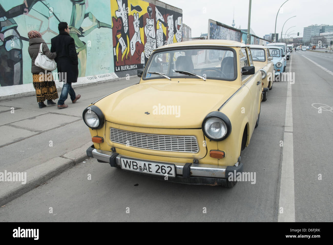 Trabant motor vehicle parked adjacent the Berlin Wall at the Eastside ...